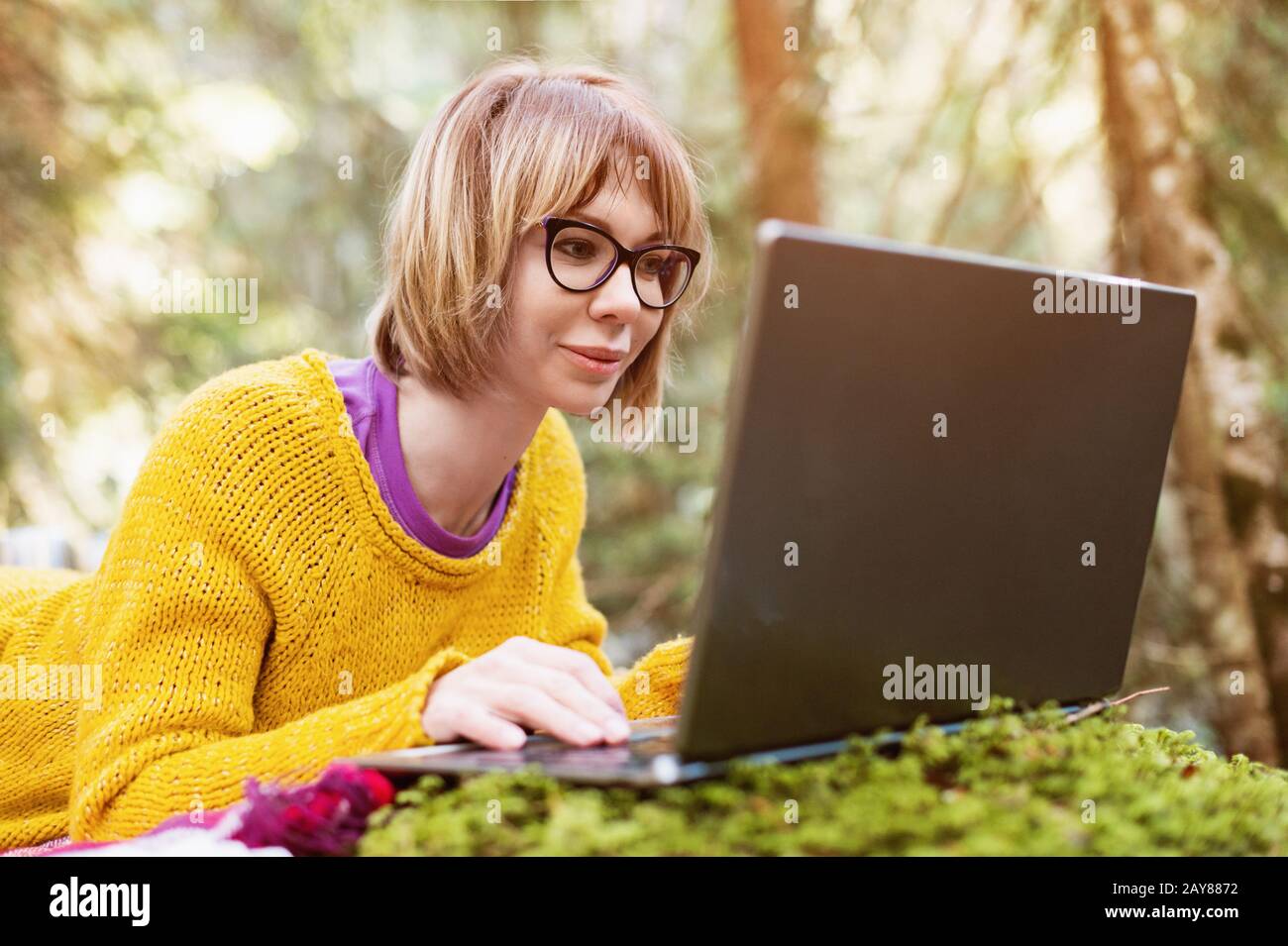 Close-up Toned image of a freelancer girl portrait in a yellow sweater ...