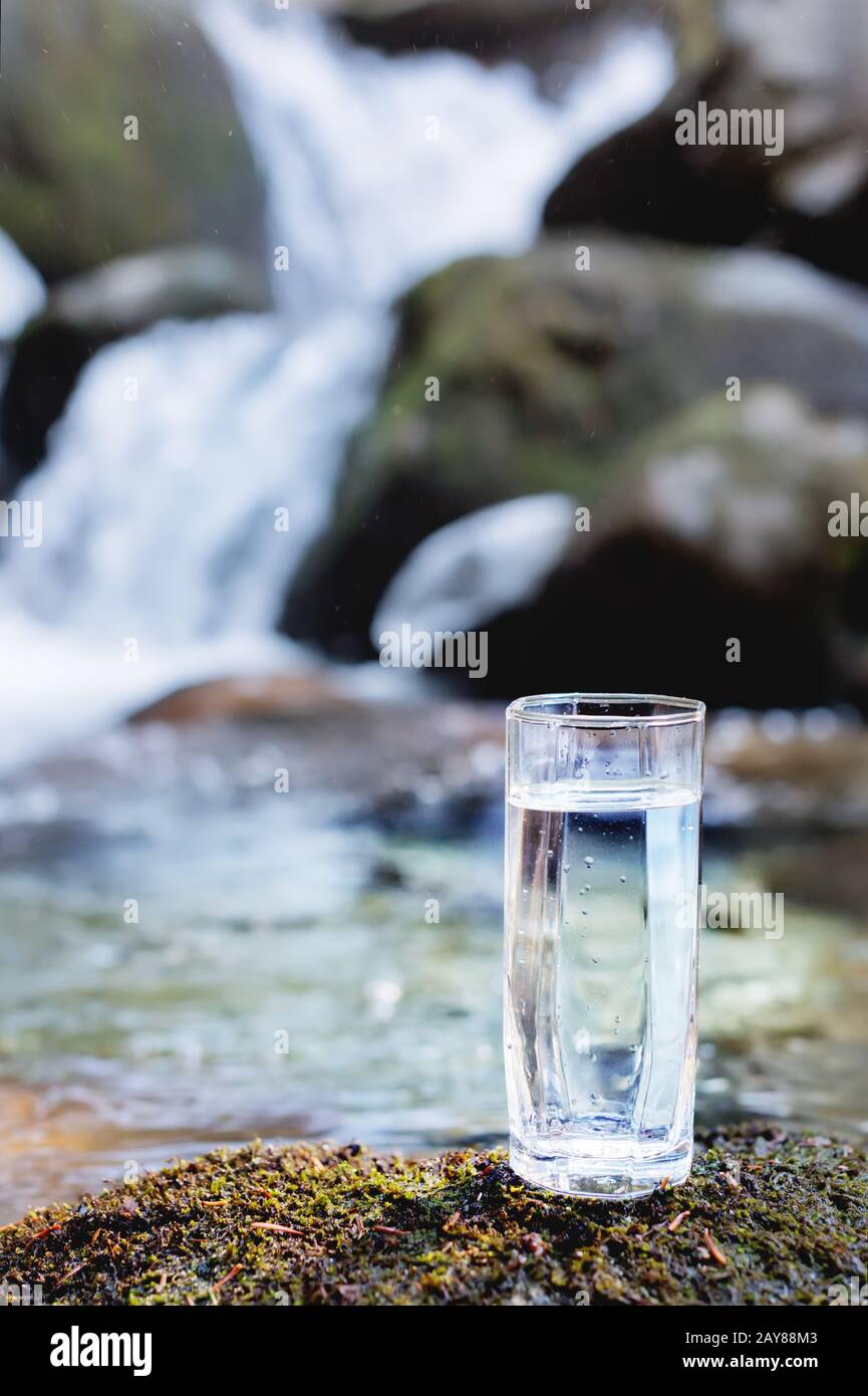 A transparent glass glass with drinking mountain water stands in the ...
