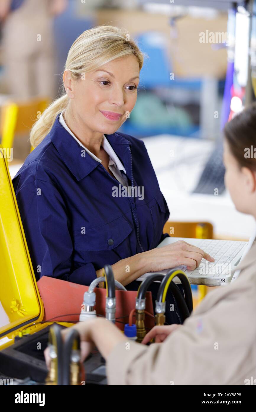 female electrician and apprentice choosing the right cables Stock Photo ...