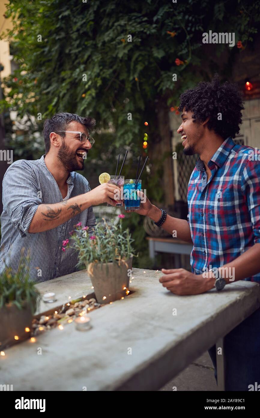 Gay men chatting in bar hi-res stock photography and images - Alamy