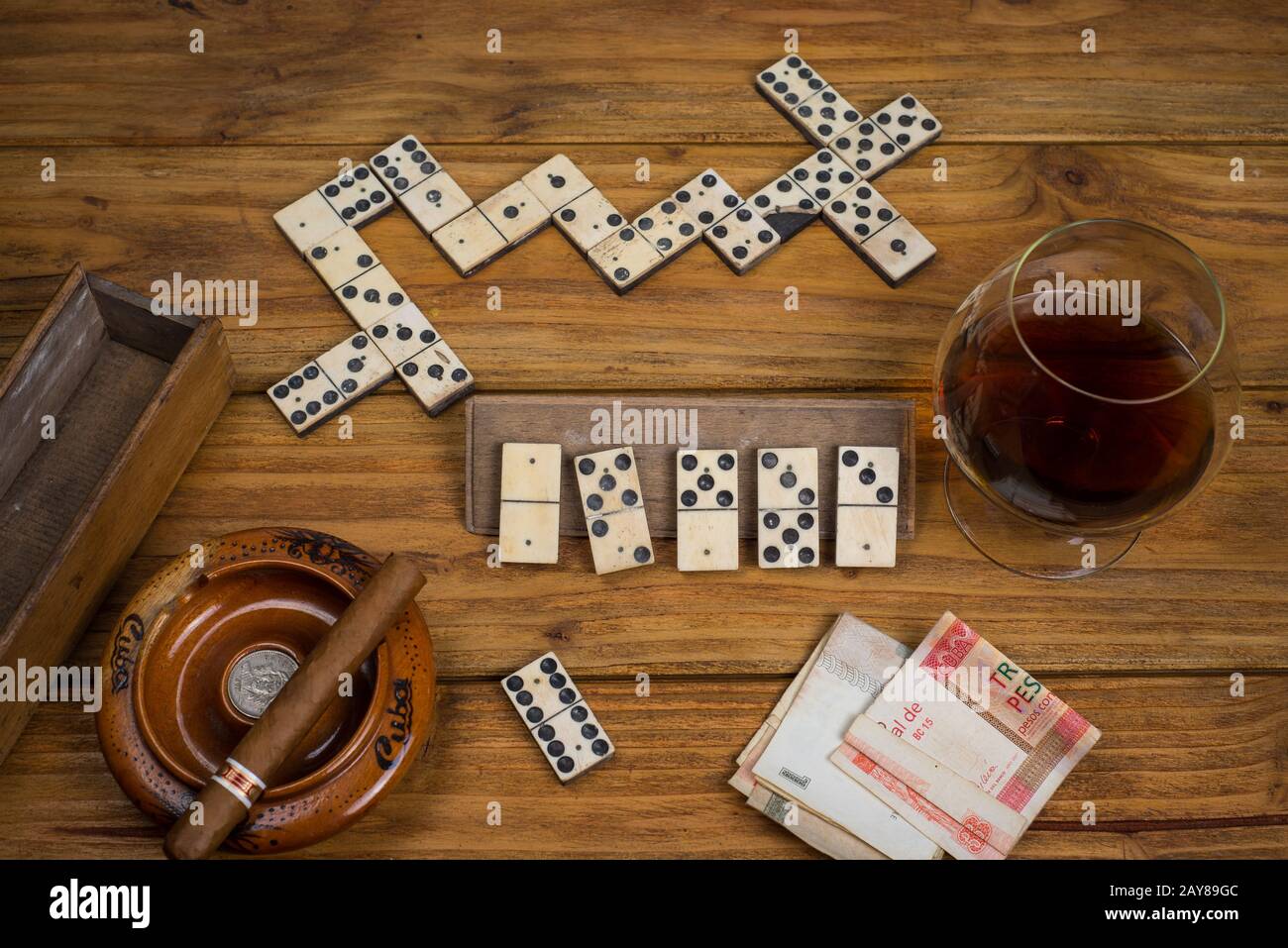 Top table view on cuban cigar and domino Stock Photo - Alamy