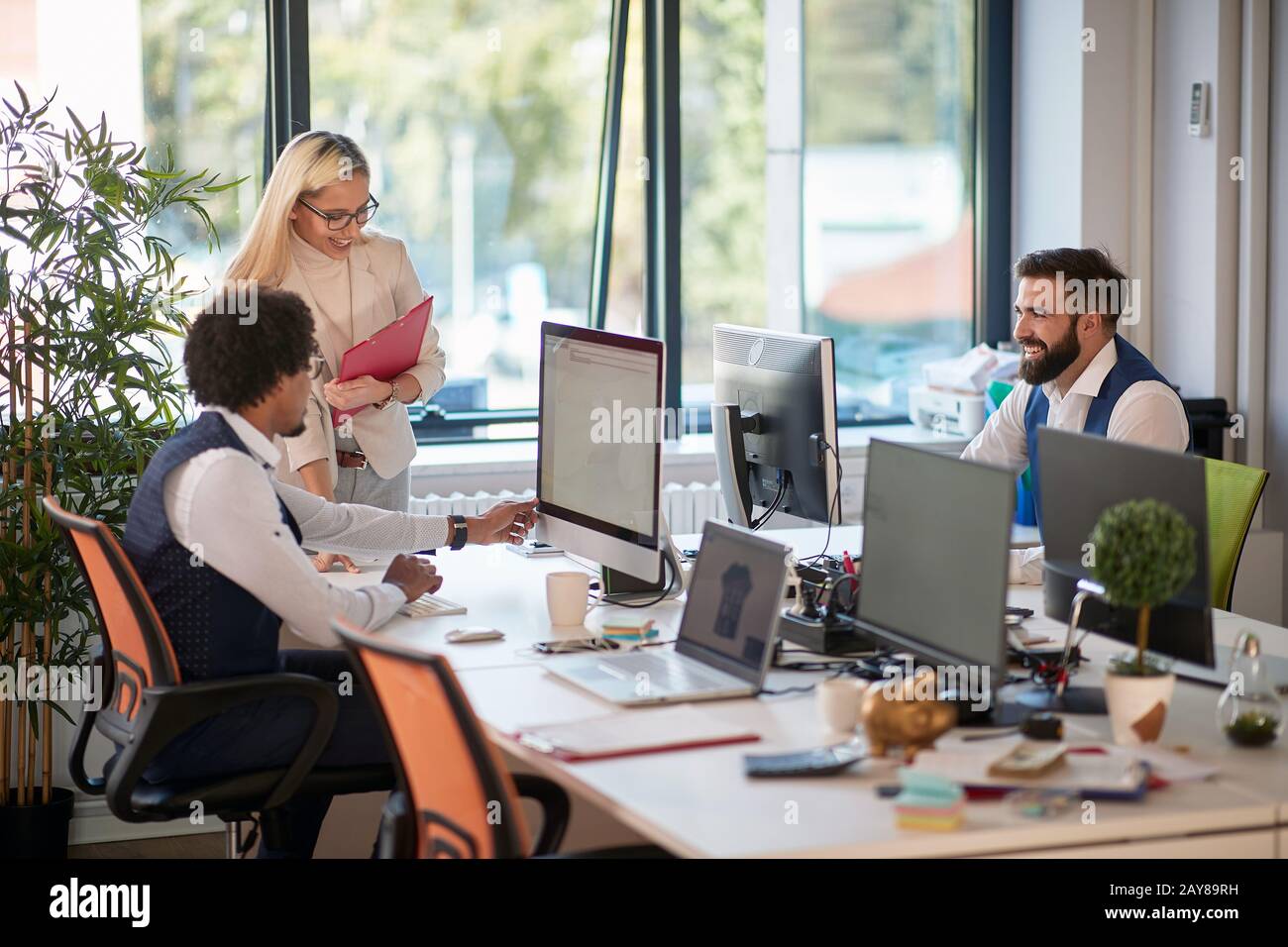 group of three colleagues in open space office. teamwork, success ...