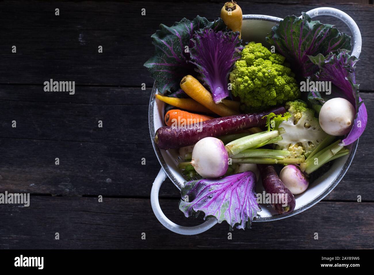Fresh vegetables in rustic colander Stock Photo - Alamy