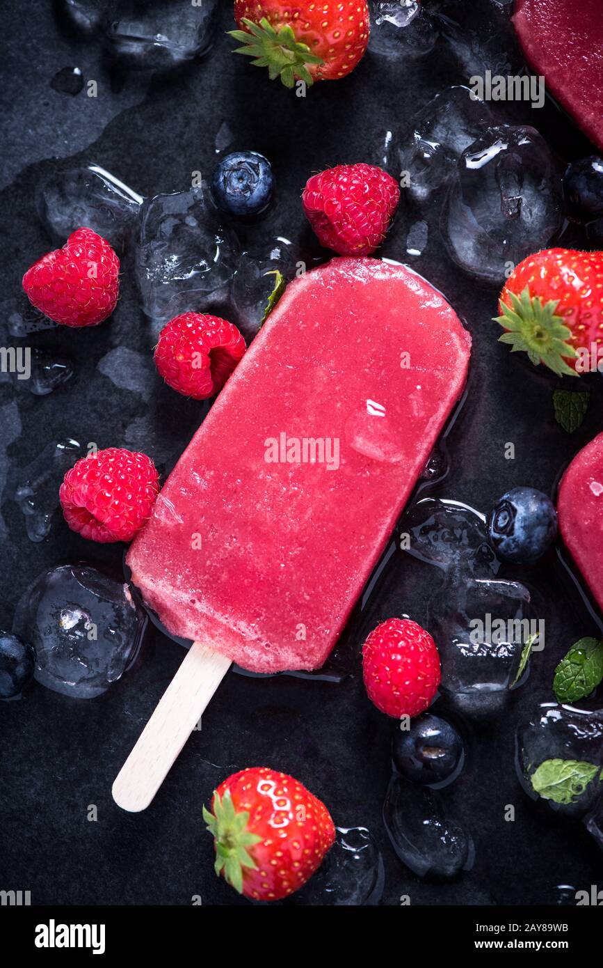 Refreshing popsicle on ice cubes and fruits Stock Photo - Alamy