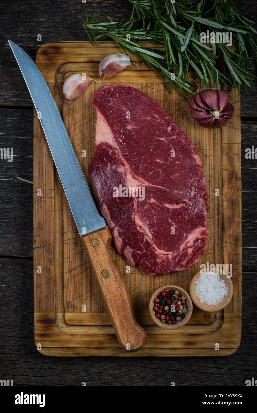 Raw ribeye beef steak with herbs and spices from above Stock Photo - Alamy