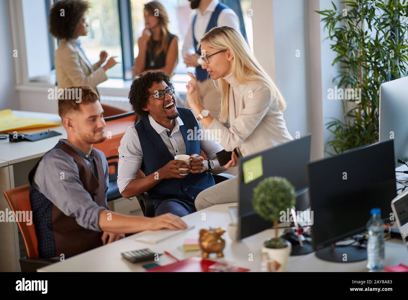 colleagues laughing at work in modern office. casual business Stock ...
