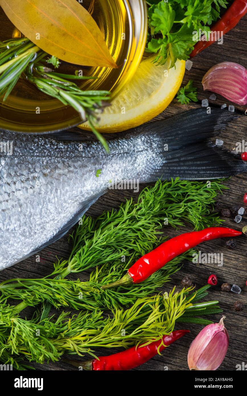 Fresh whole sea fish with aromatic herbs and spices Stock Photo - Alamy