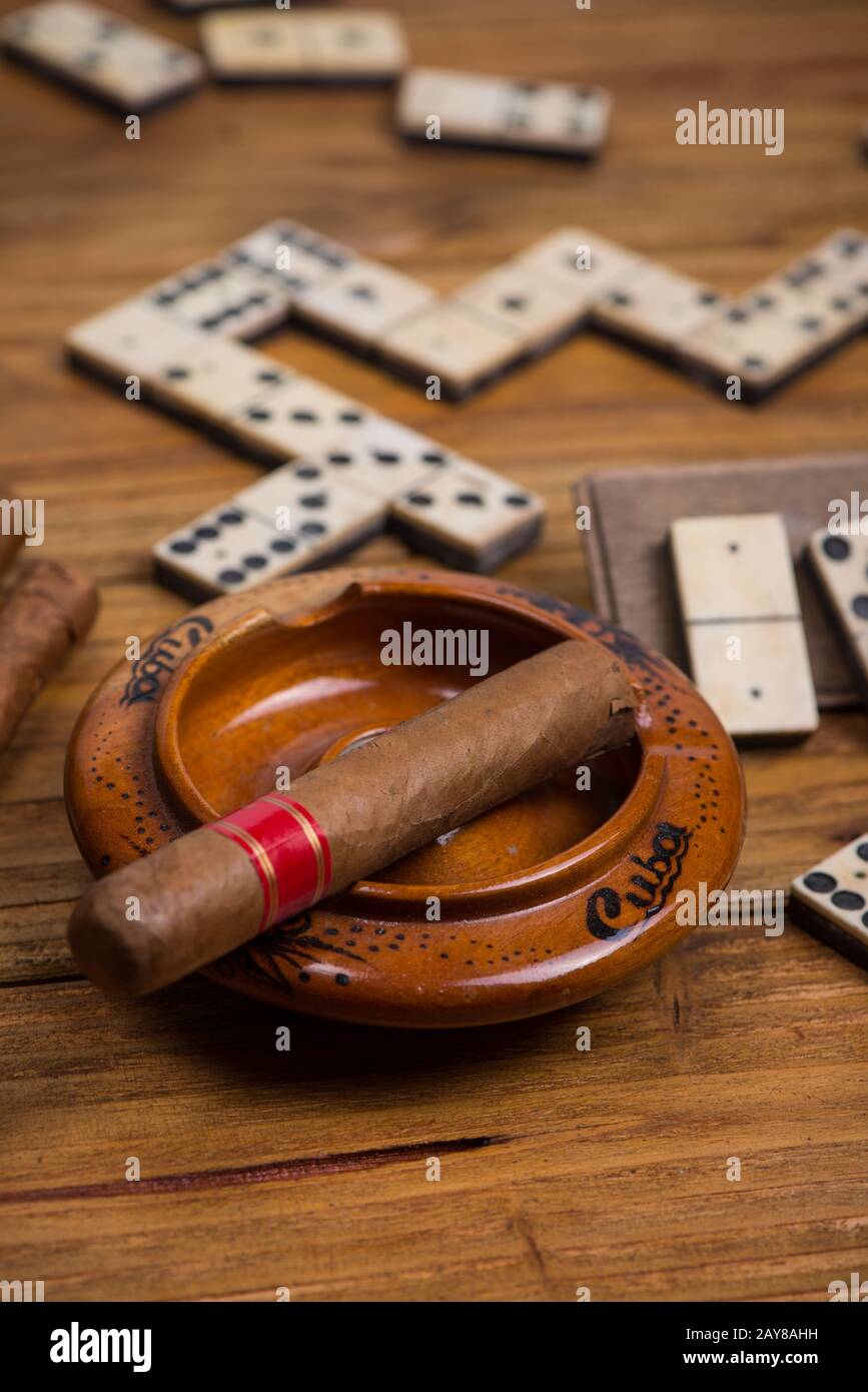 Cuban cigar on table with domino game Stock Photo - Alamy