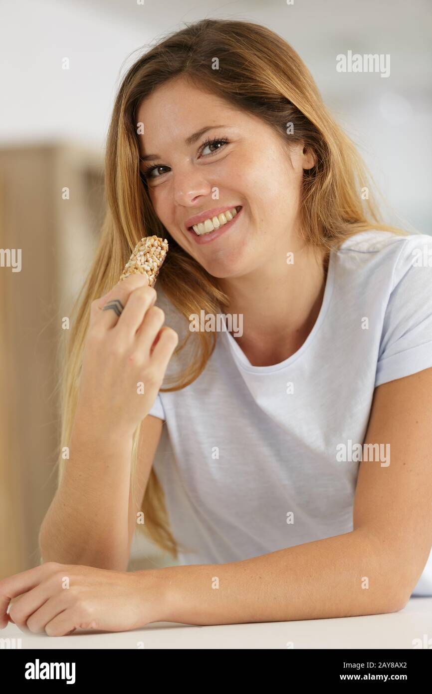 Girl eating cereal bar hi-res stock photography and images - Alamy