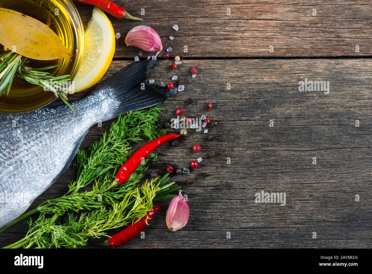 Fresh whole sea fish with aromatic herbs and spices Stock Photo - Alamy