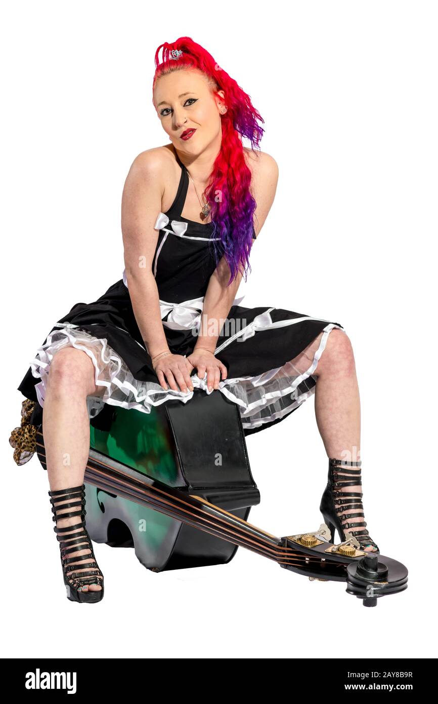 Female Rock'n'Roll singer with red hair sits on a double bass Stock ...