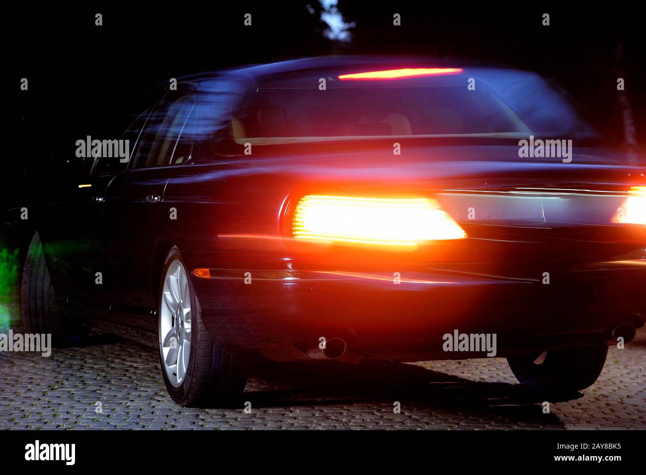 Red car in motion hi-res stock photography and images - Alamy