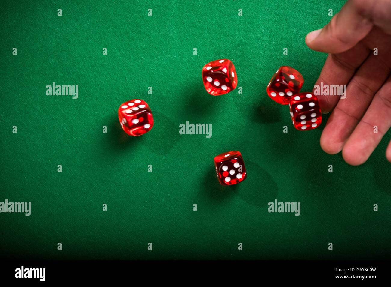 Hand Rolling Dice On Table