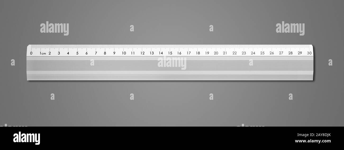 Metal ruler isolated on dark grey background Stock Photo - Alamy