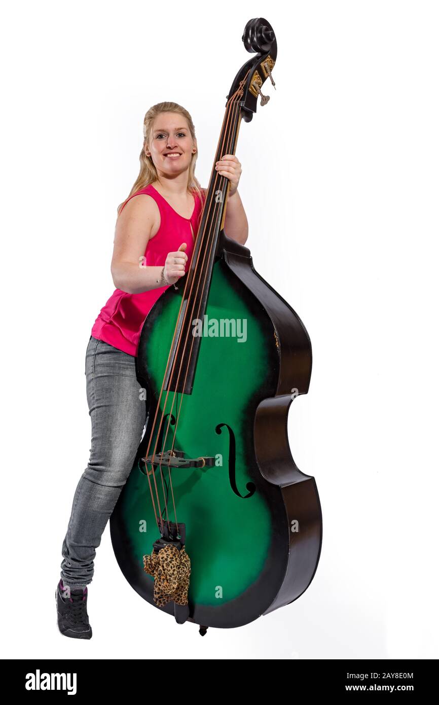 Female musician with red shirt plays on a double bass in front of white ...