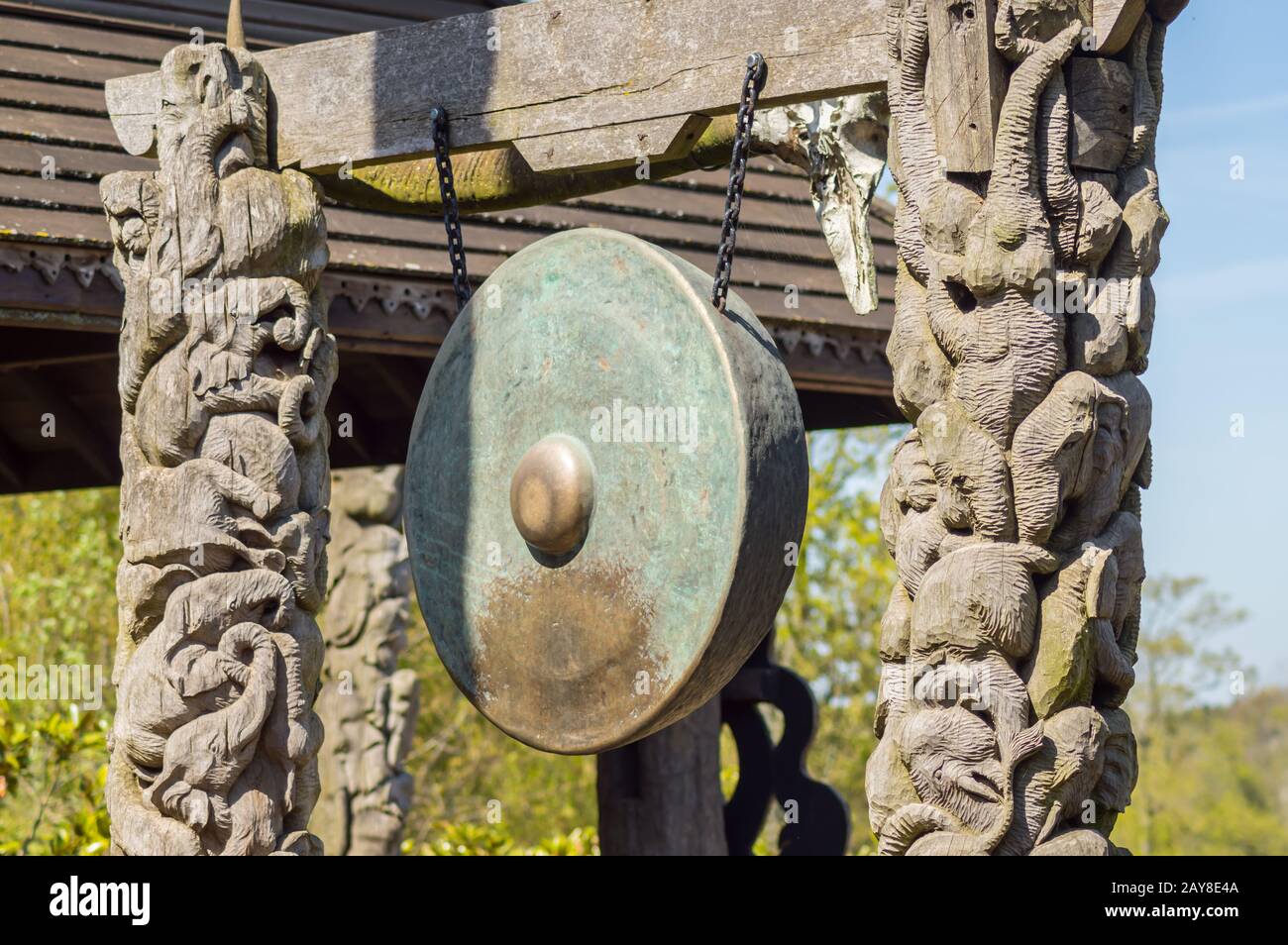 Buddhist prayer drum hanging from a carved Stock Photo - Alamy