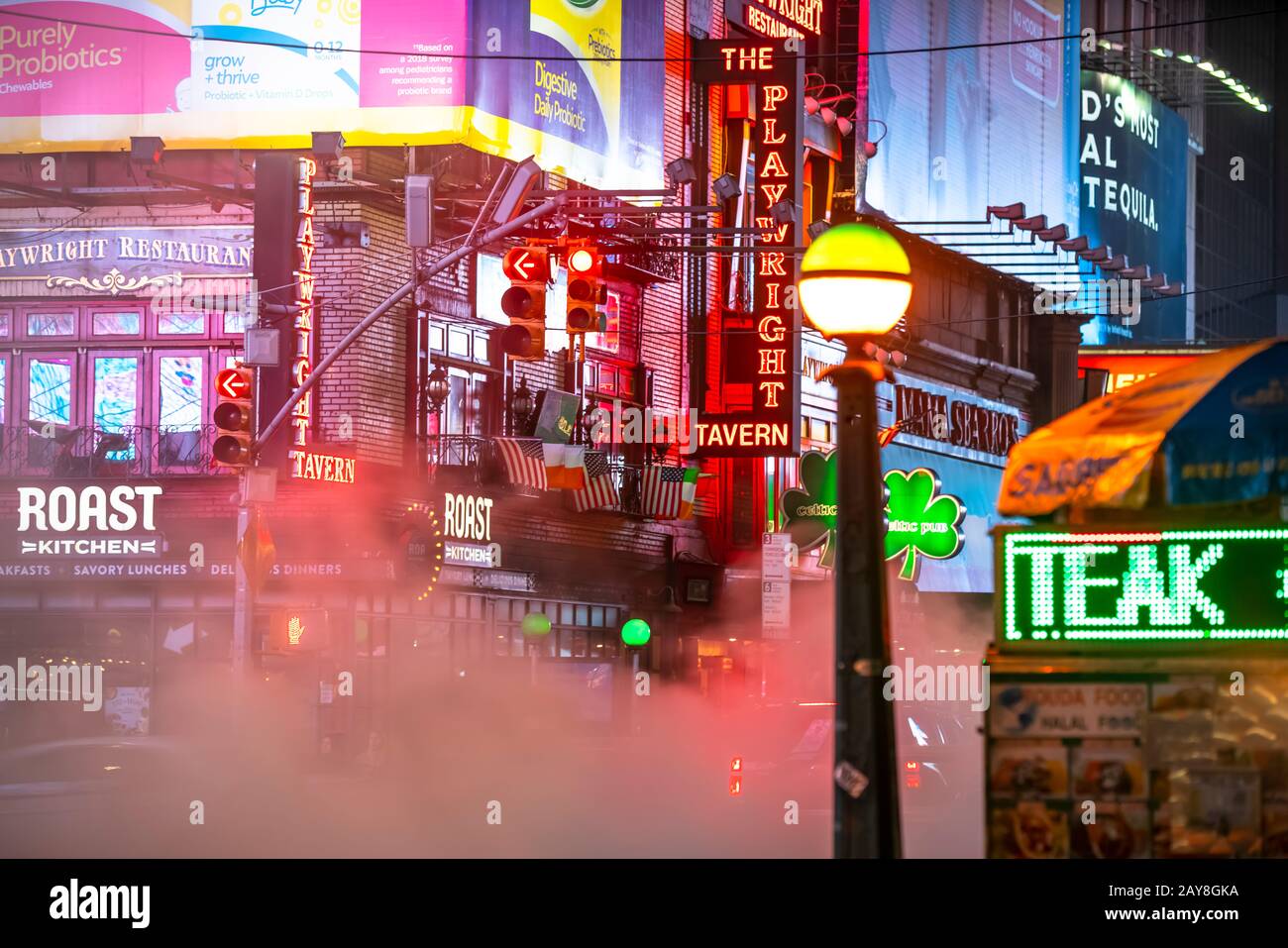 The steam drifts and surrounds the Subway Globes Light and cityscape in ...