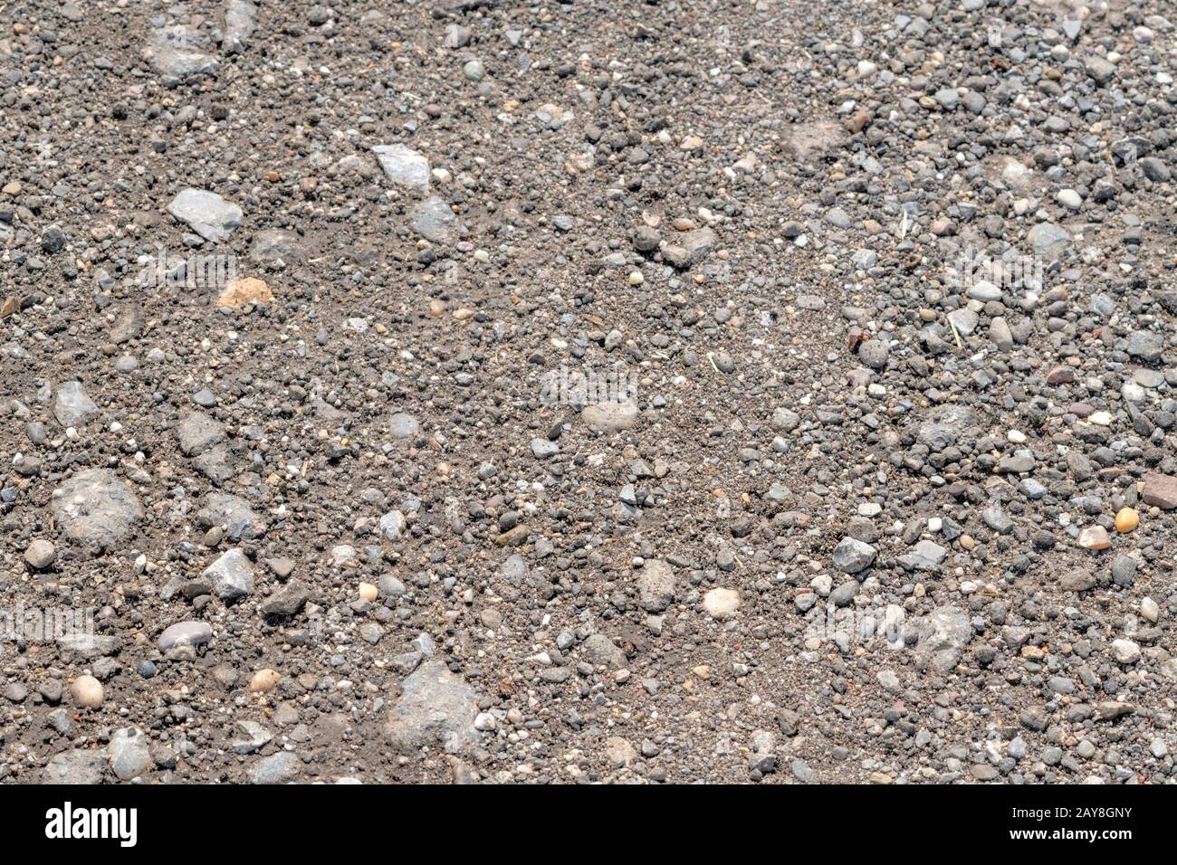 Flat rolled gray sandy soil with pebbles as background Stock Photo - Alamy
