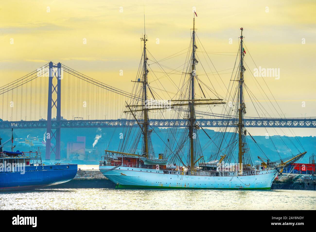 Ship by bridge at sunset Stock Photo - Alamy