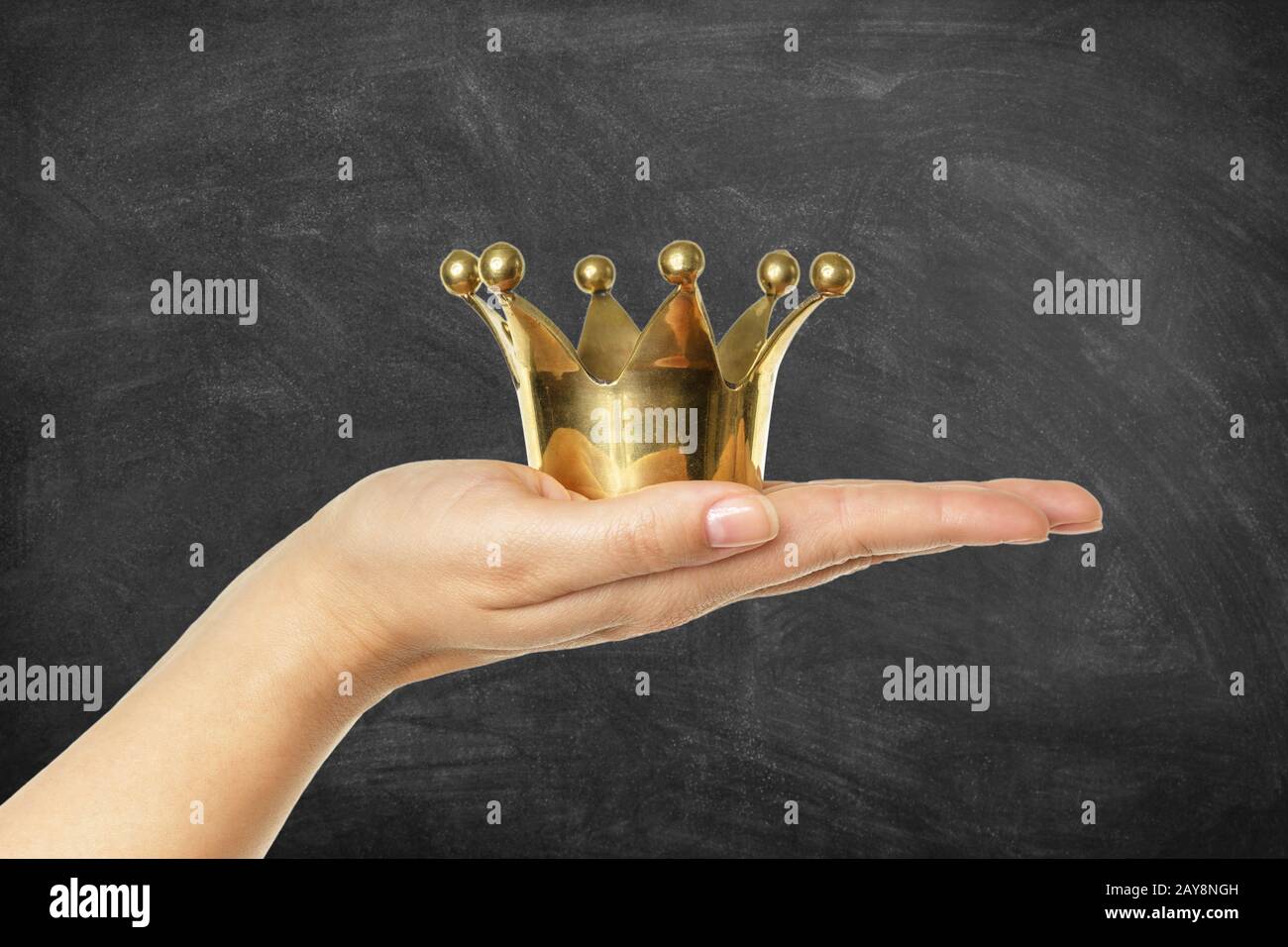 Hand holding a crown hi-res stock photography and images - Alamy
