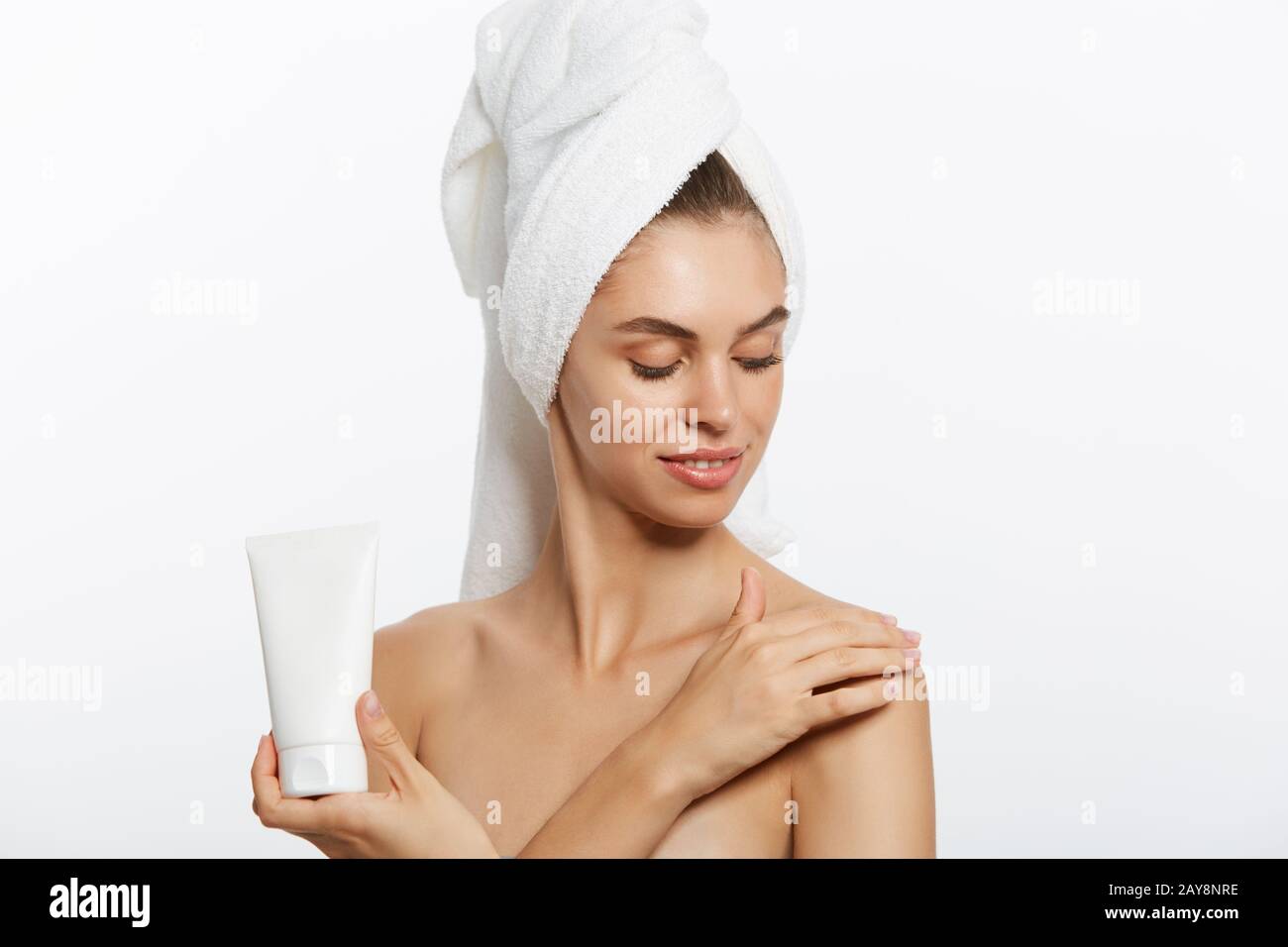 Woman applying cream on shoulder on a white background Stock Photo - Alamy