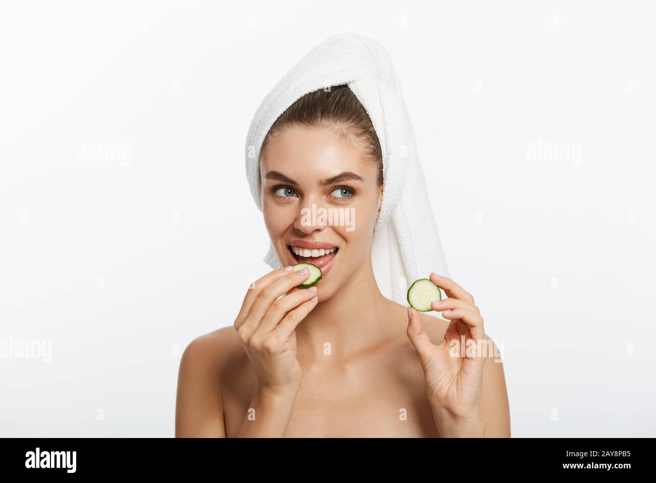 Pretty young natural girl with perfect clean skin looking at camera ...