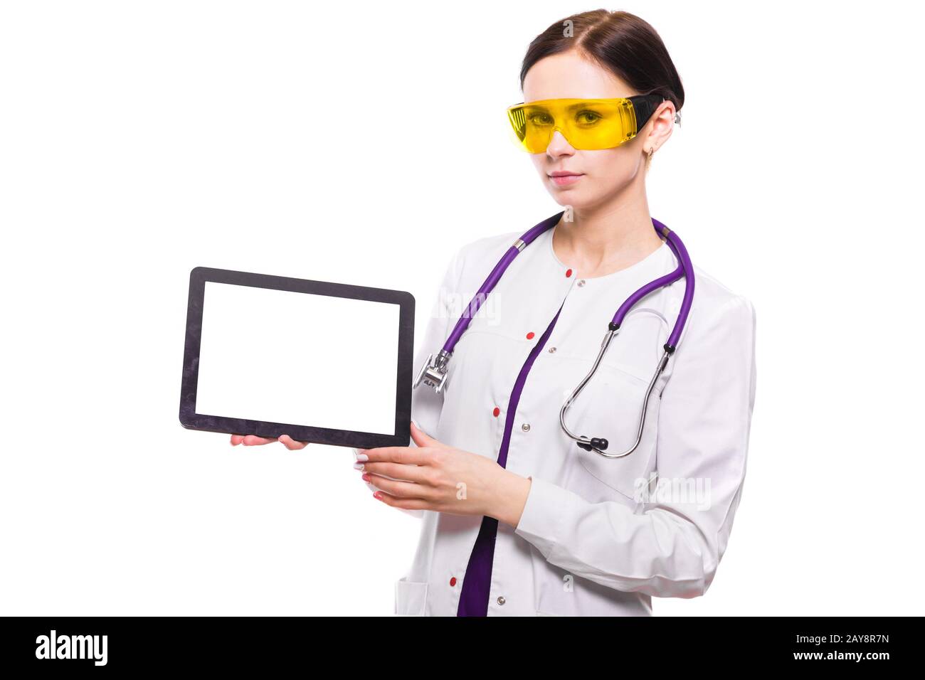 Young beautiful female doctor holding tablet in her hands on white ...