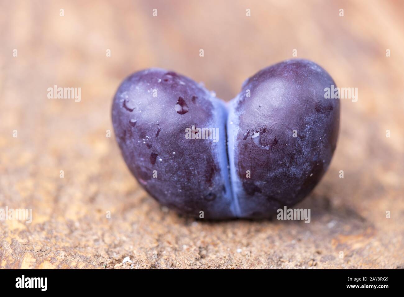 Heart-shaped plum on dark wood Stock Photo - Alamy