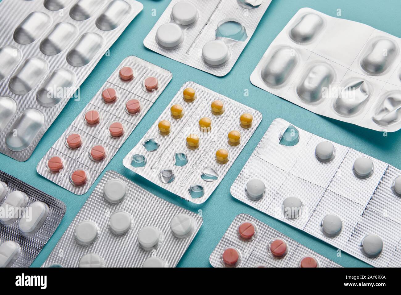 Different medicine pills wrappers over sky blue background. Top View ...