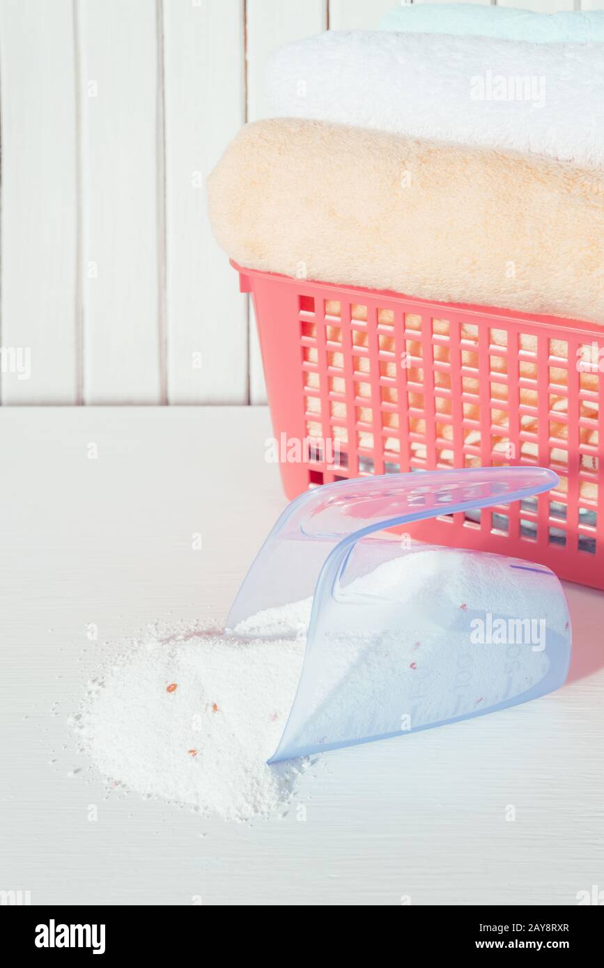 Bath towels and washing powder in measuring cup Stock Photo - Alamy