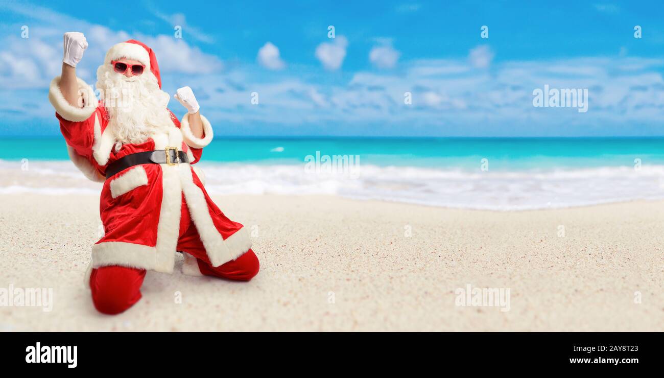 Cheerful Santa Claus is happy about his perfect sunny vacation ...
