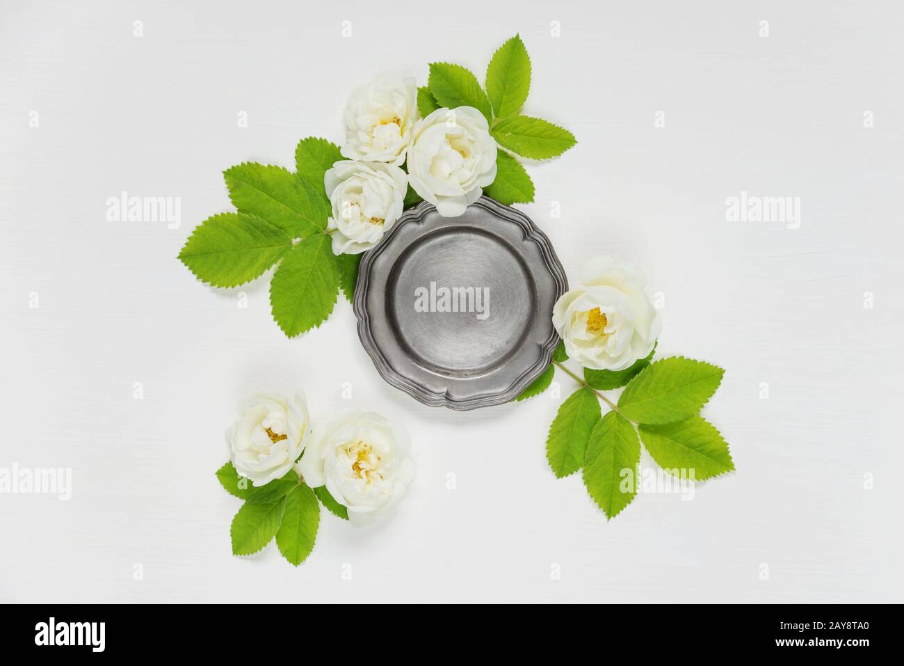 Decorative composition with metal plate and rose flowers Stock Photo ...