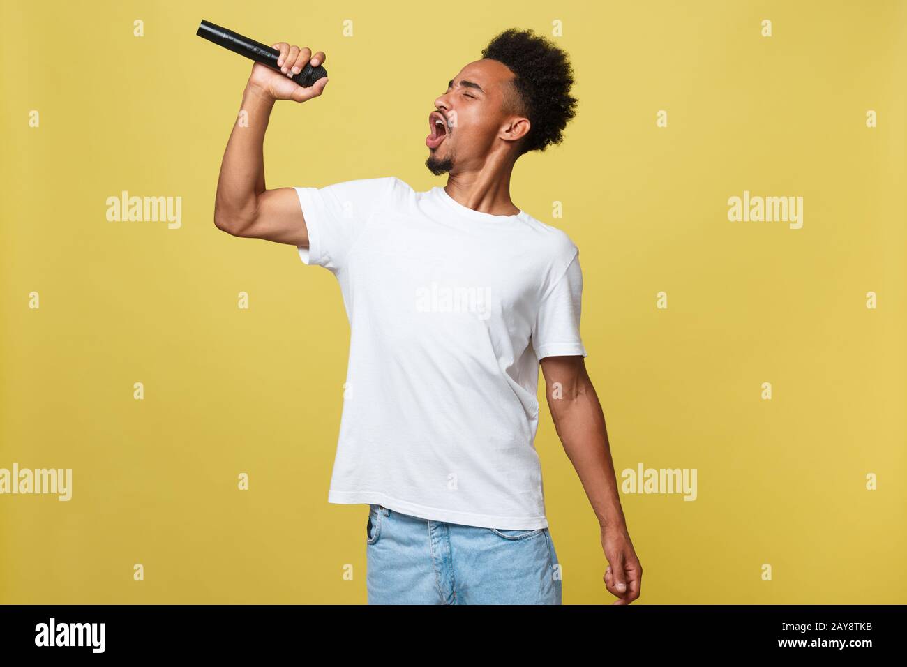 Young handsome African American Male Singer Performing with Microphone ...