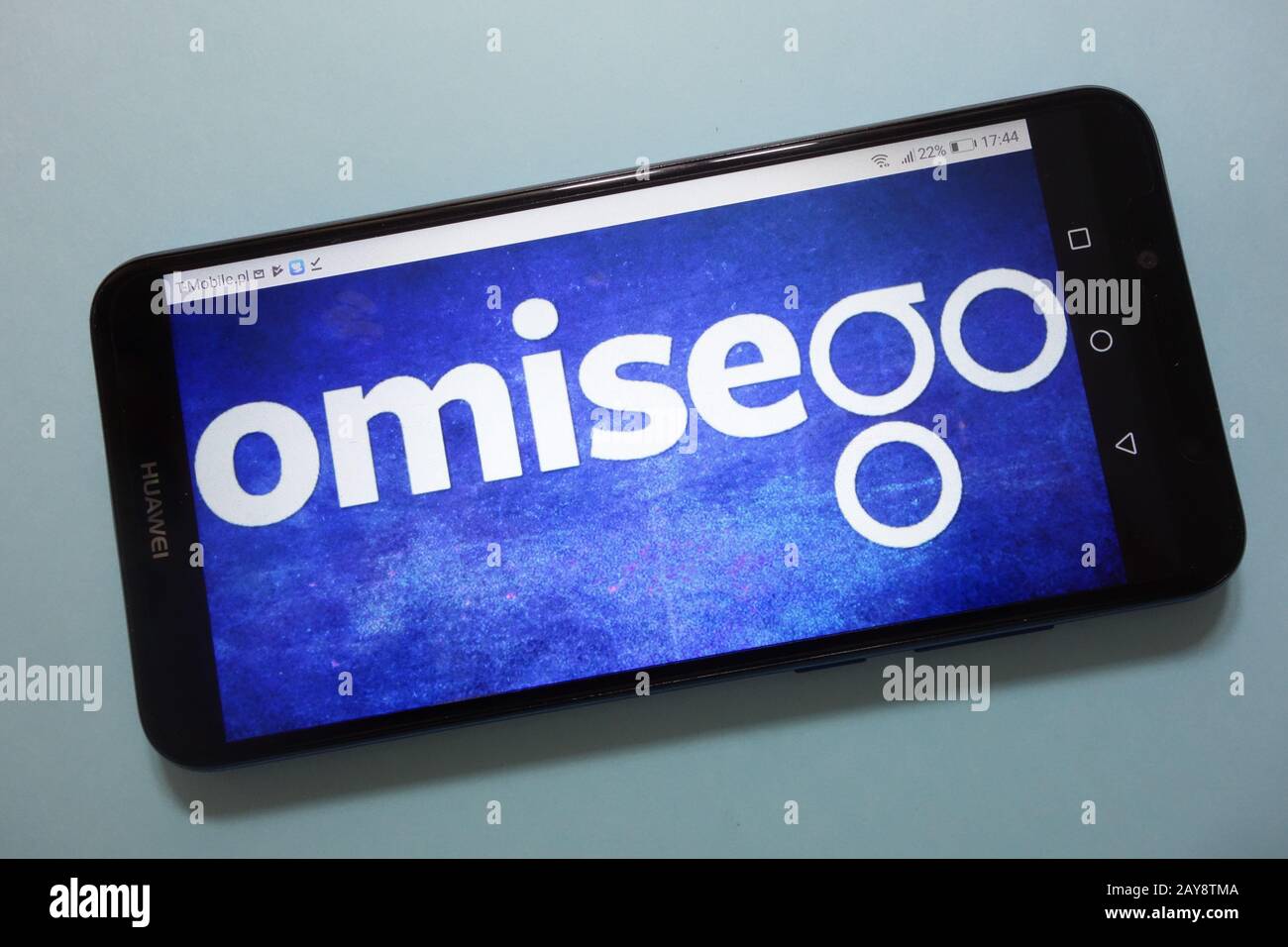 OmiseGO (OMG) cryptocurrency logo displayed on smartphone Stock Photo ...