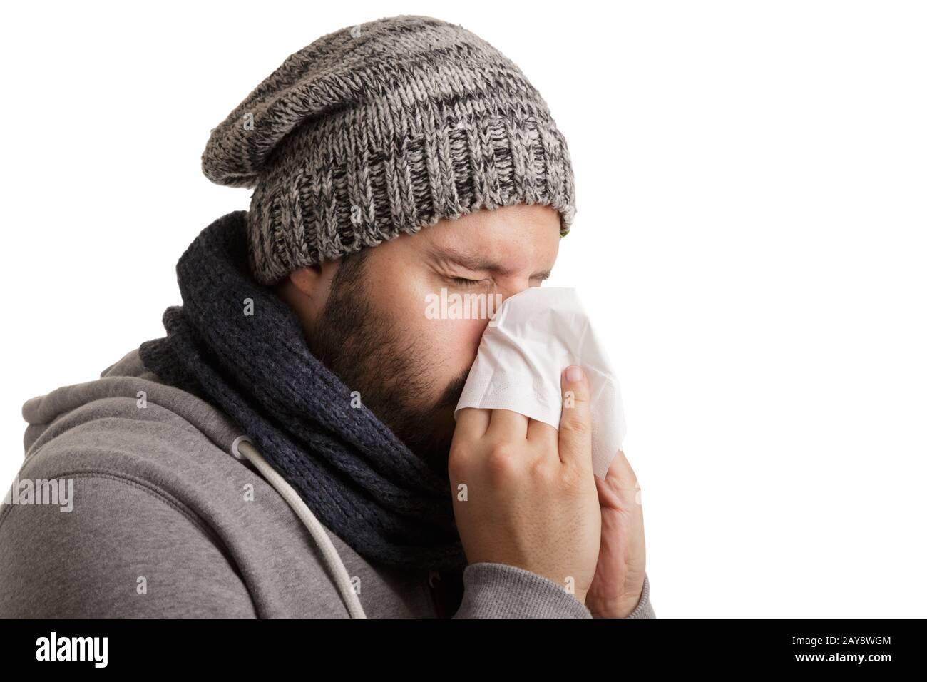 A man in winter time with disease has to sneeze and blow into a ...