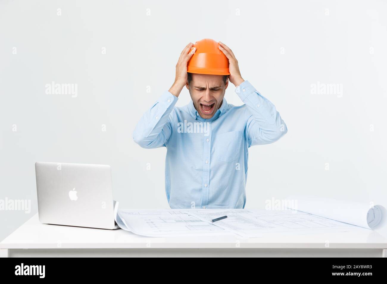 Focused serious hardworking engineer busy working on big architectural ...