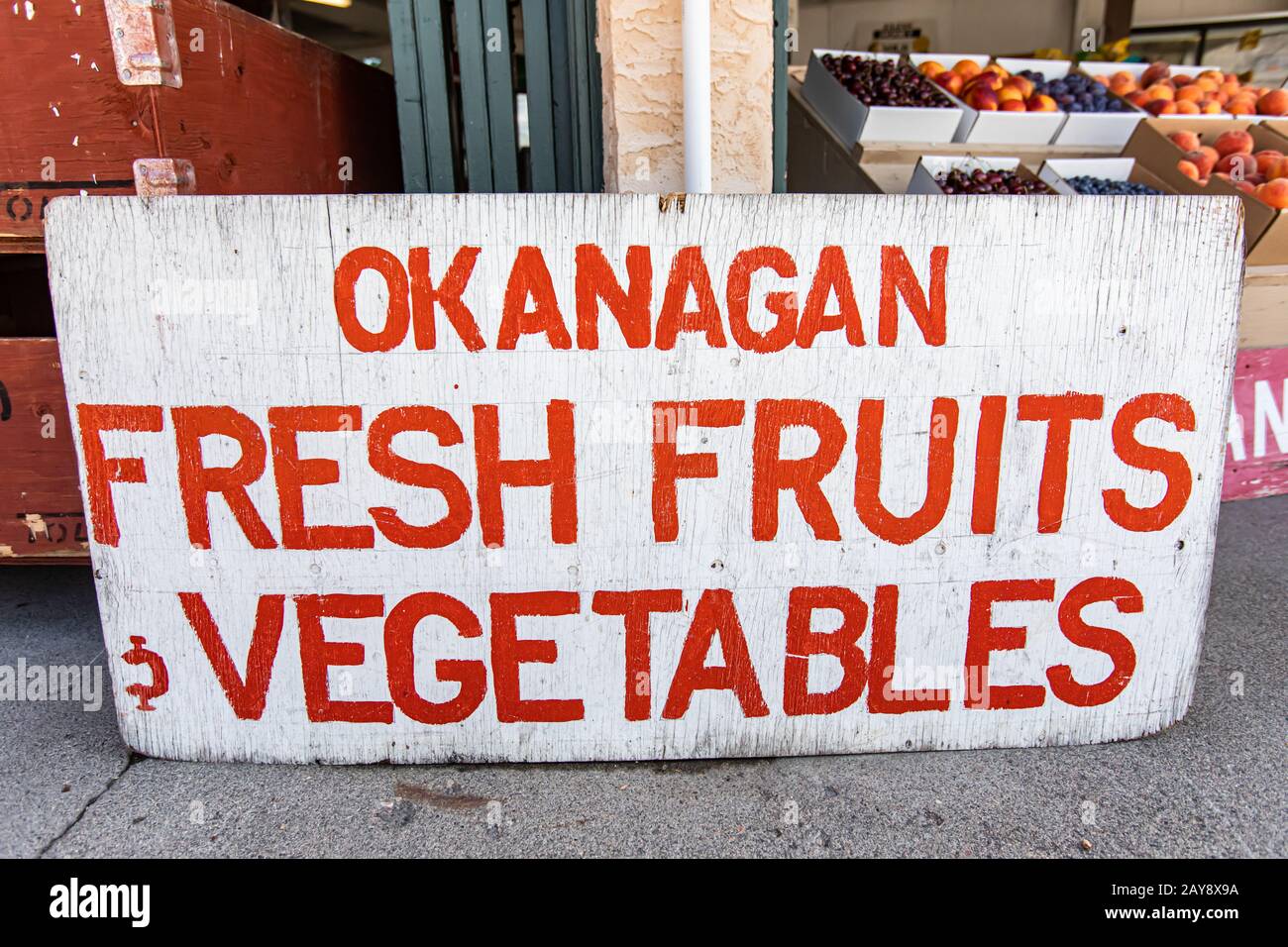 Big white wooden sign with red painted capital letters reading Okanagan ...
