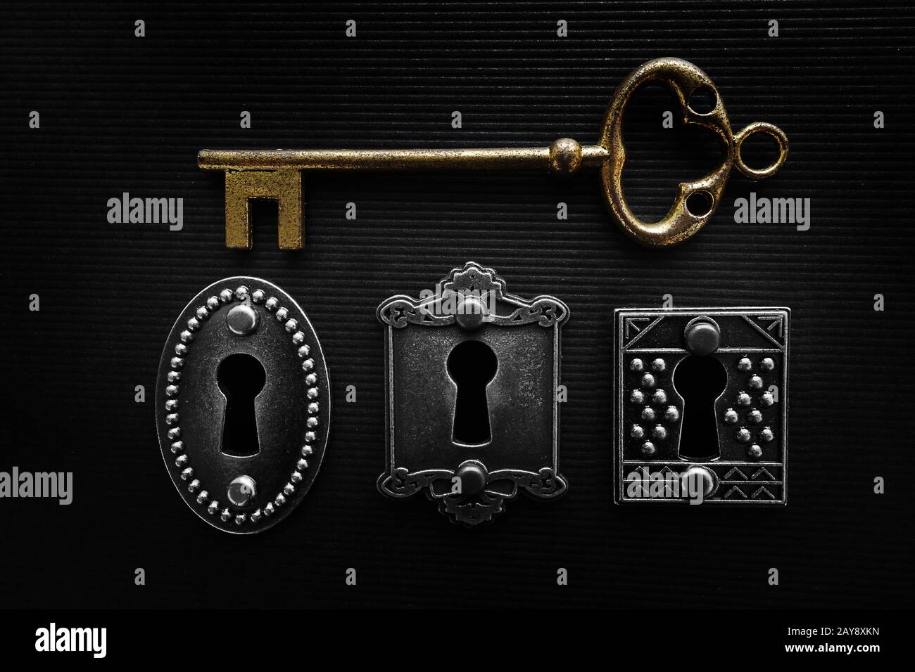 Three locks and gold key Stock Photo - Alamy