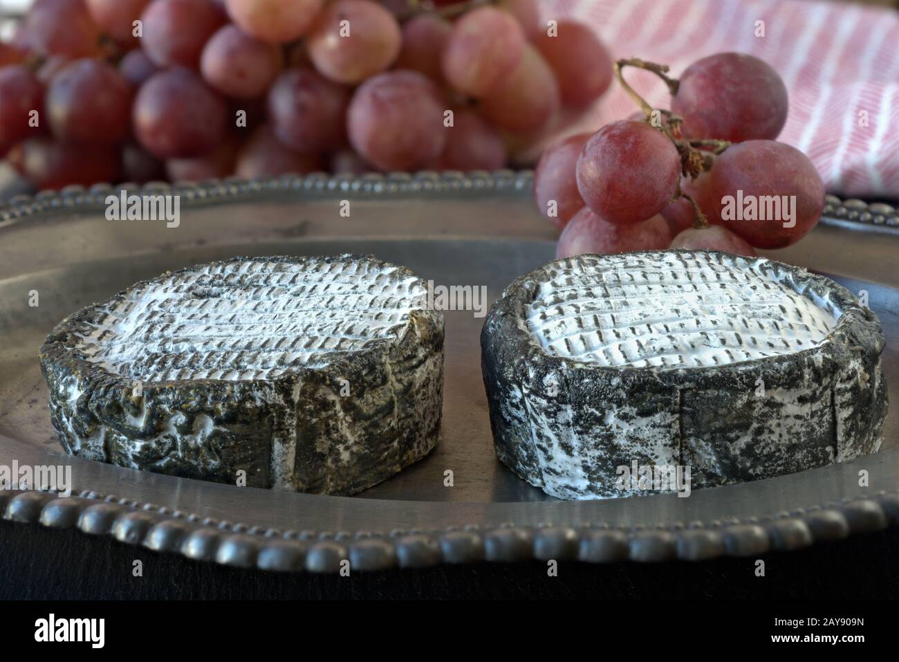 French soft cheese with grey mould and grapes Stock Photo - Alamy