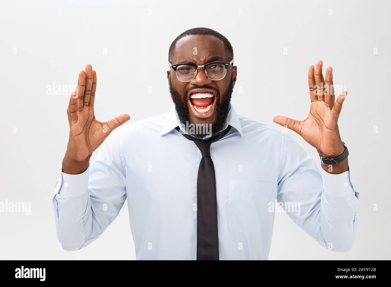 Portrait of desperate annoyed black male screaming in rage and anger ...