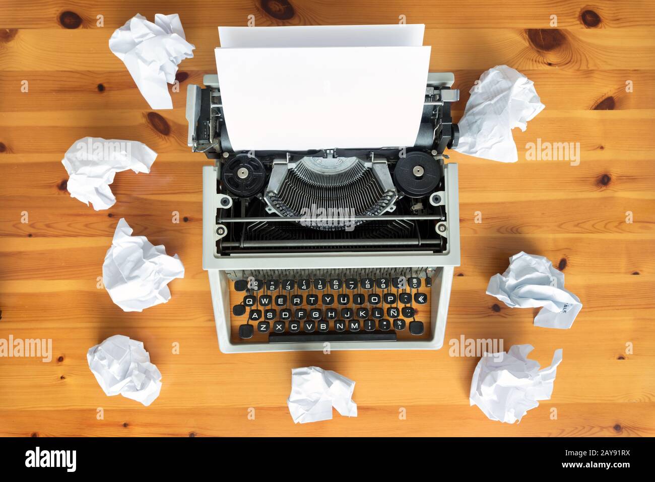 Writer's block. Typewriter and crumpled paper on work desk. Creative ...