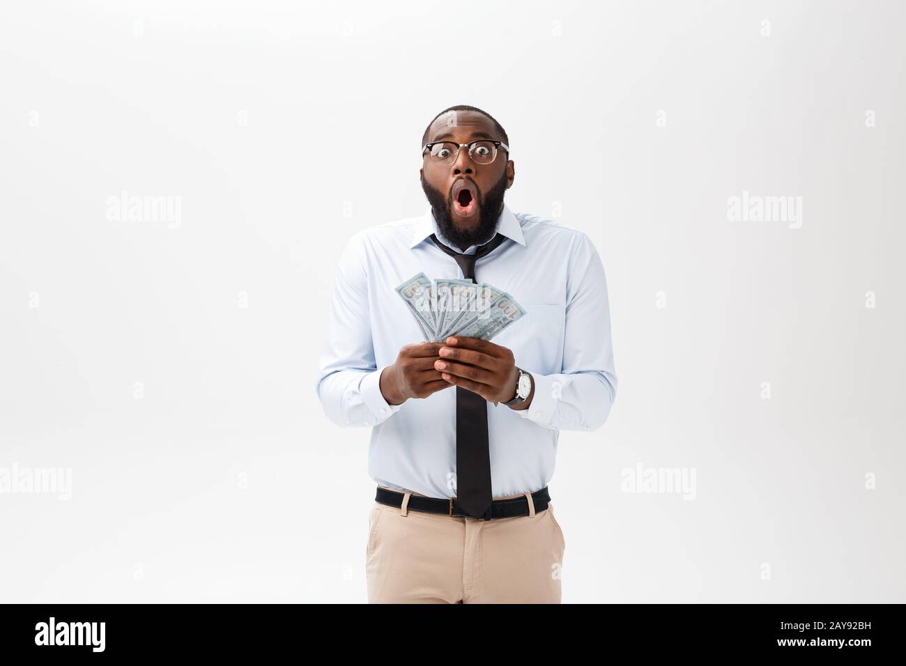 African man holding bank notes happy and surprised cheering expressing ...