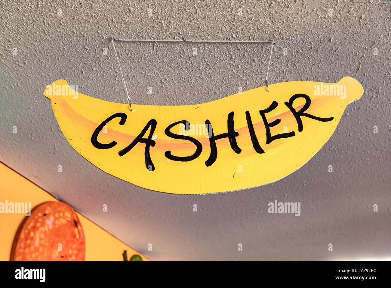hand written banana shaped signboard at the local food market. Sign ...