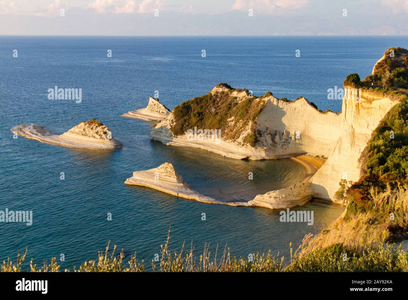 Cliffs in the island of Corfu in Greece, bathed in afternoon light ...