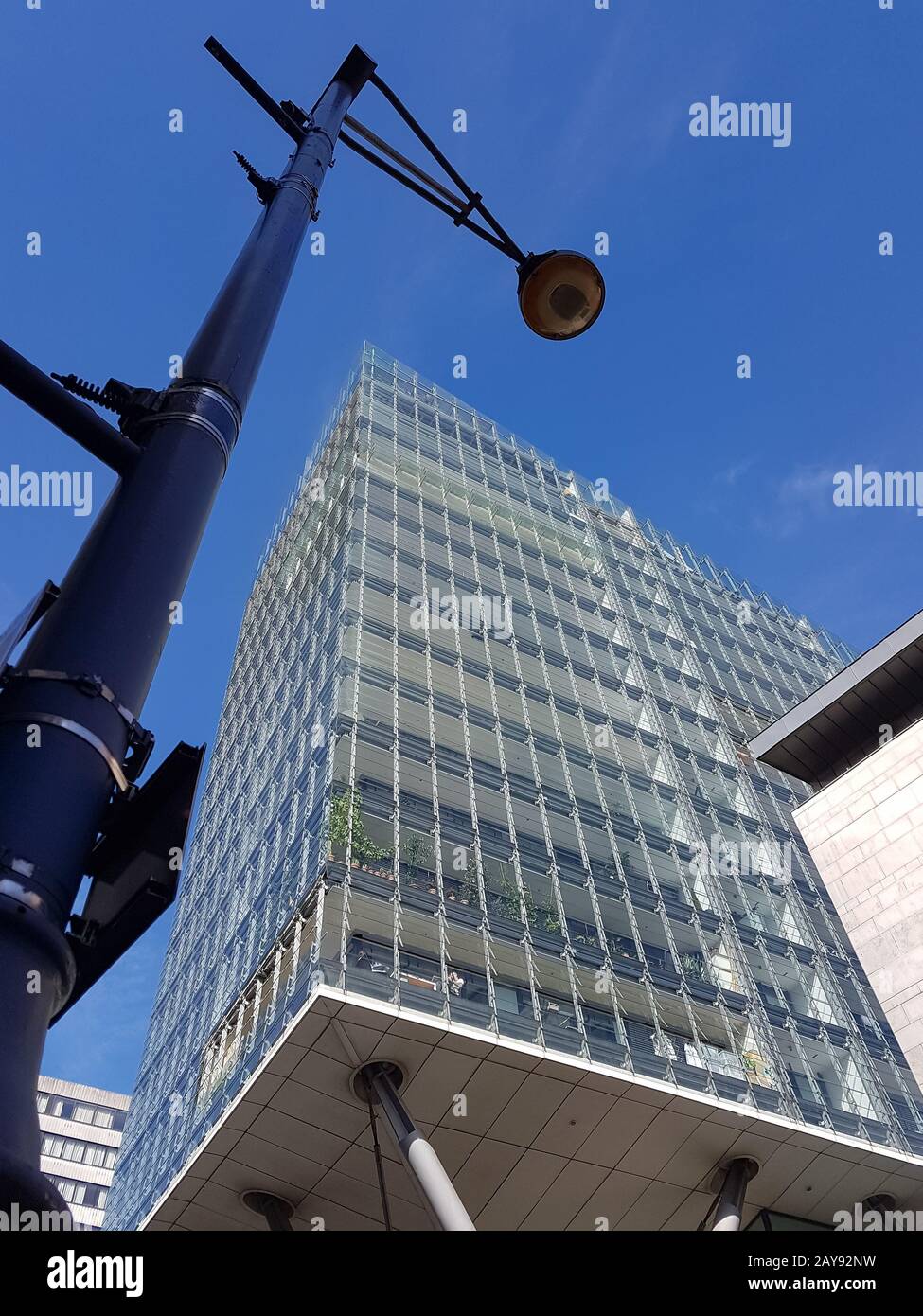 Street lamp. modern lamppost against modern building facade in daylight ...