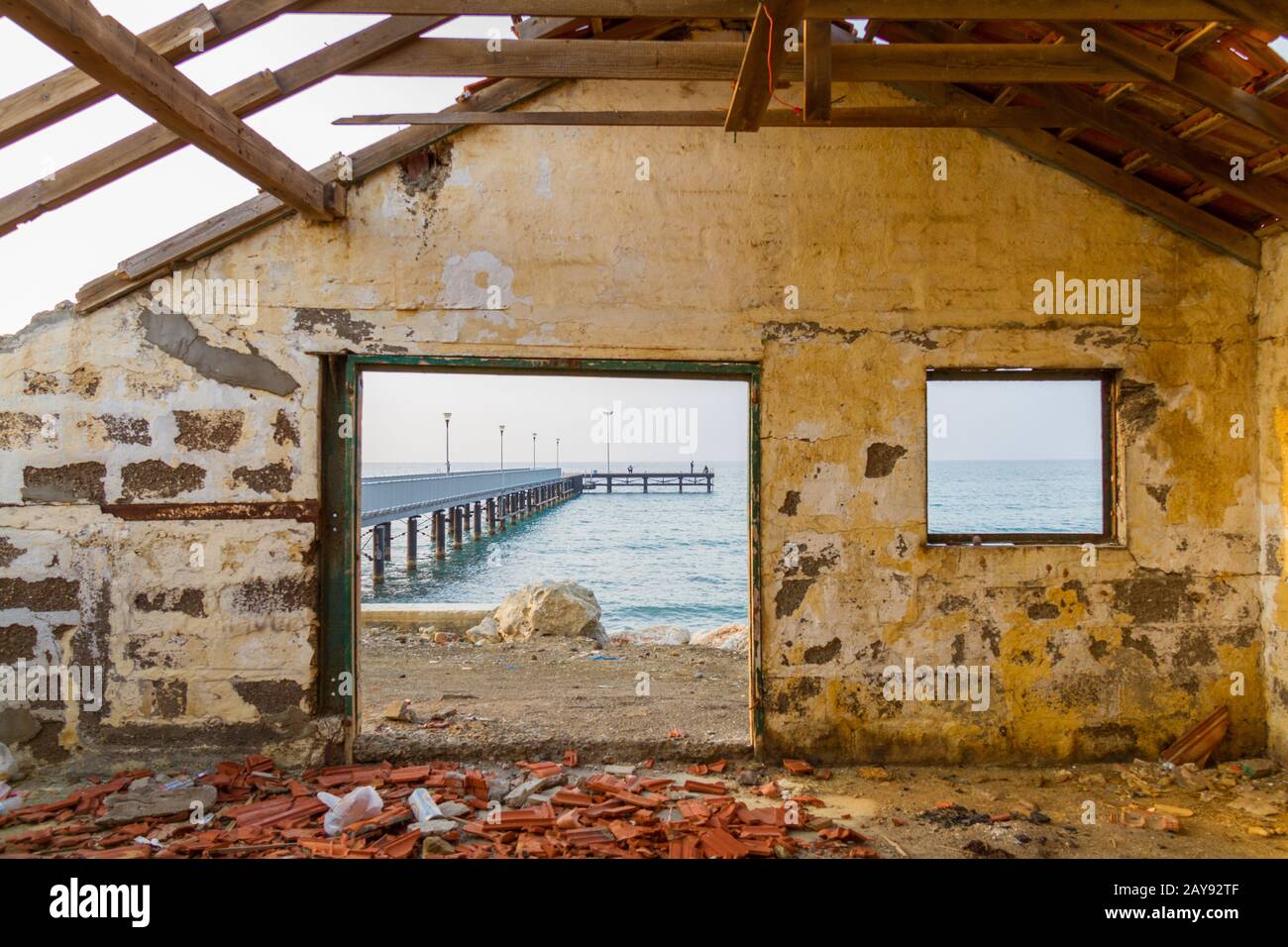 Pier view through derelict house window by the beach Stock Photo - Alamy