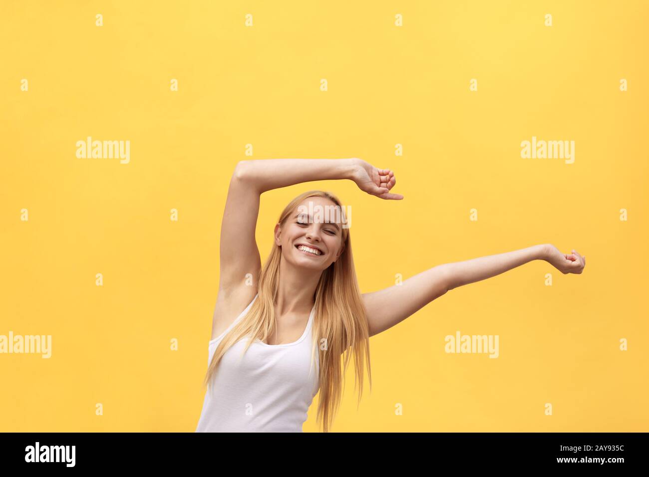 Young beautiful happy girl with hand in the air portrait isolated on ...
