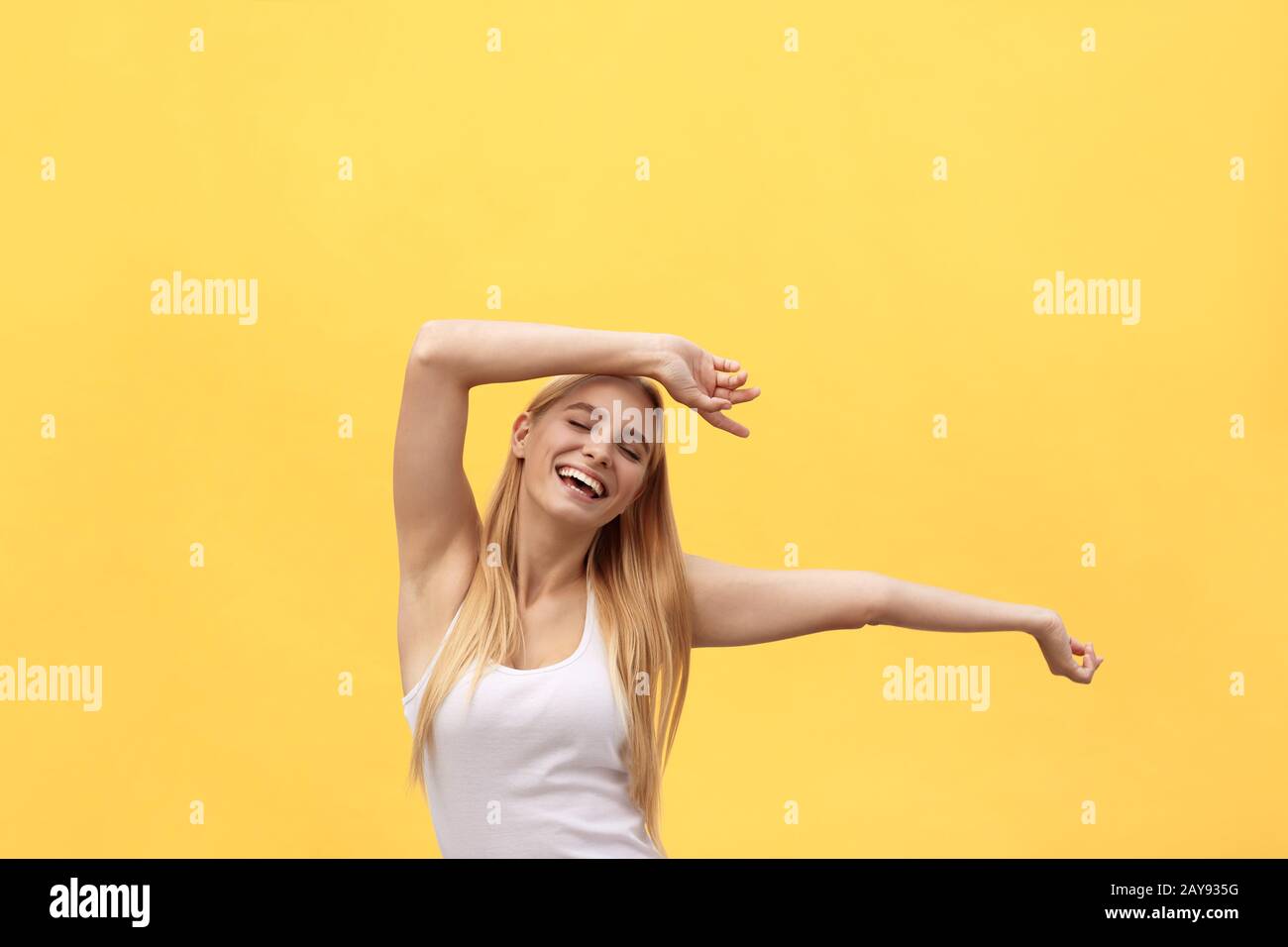 Young beautiful happy girl with hand in the air portrait isolated on ...