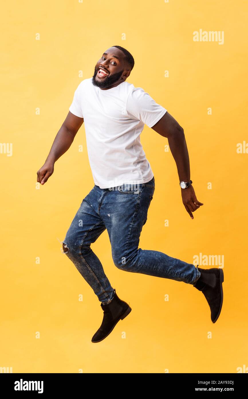Young black man jumping hi-res stock photography and images - Alamy