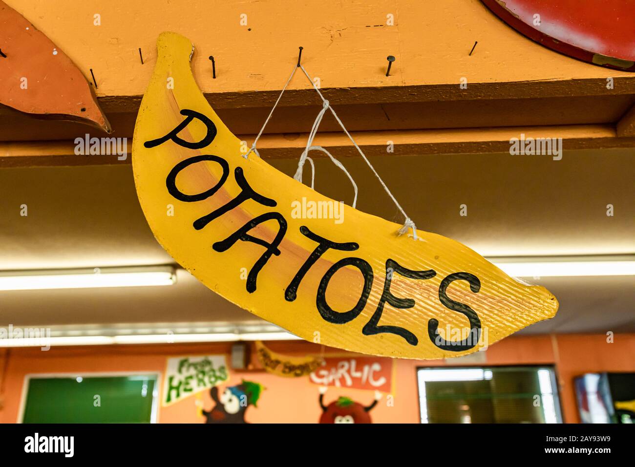 hand written banana shaped signboard at the local food market. Sign ...